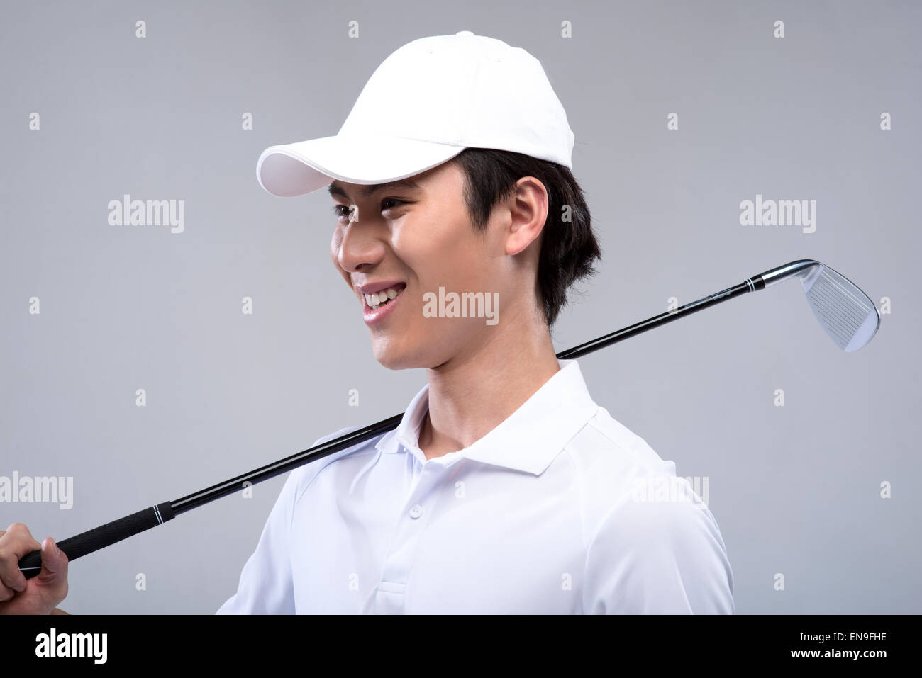 Young man playing golf Stock Photo - Alamy