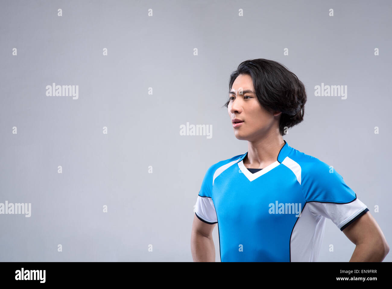 Young man playing football Stock Photo - Alamy