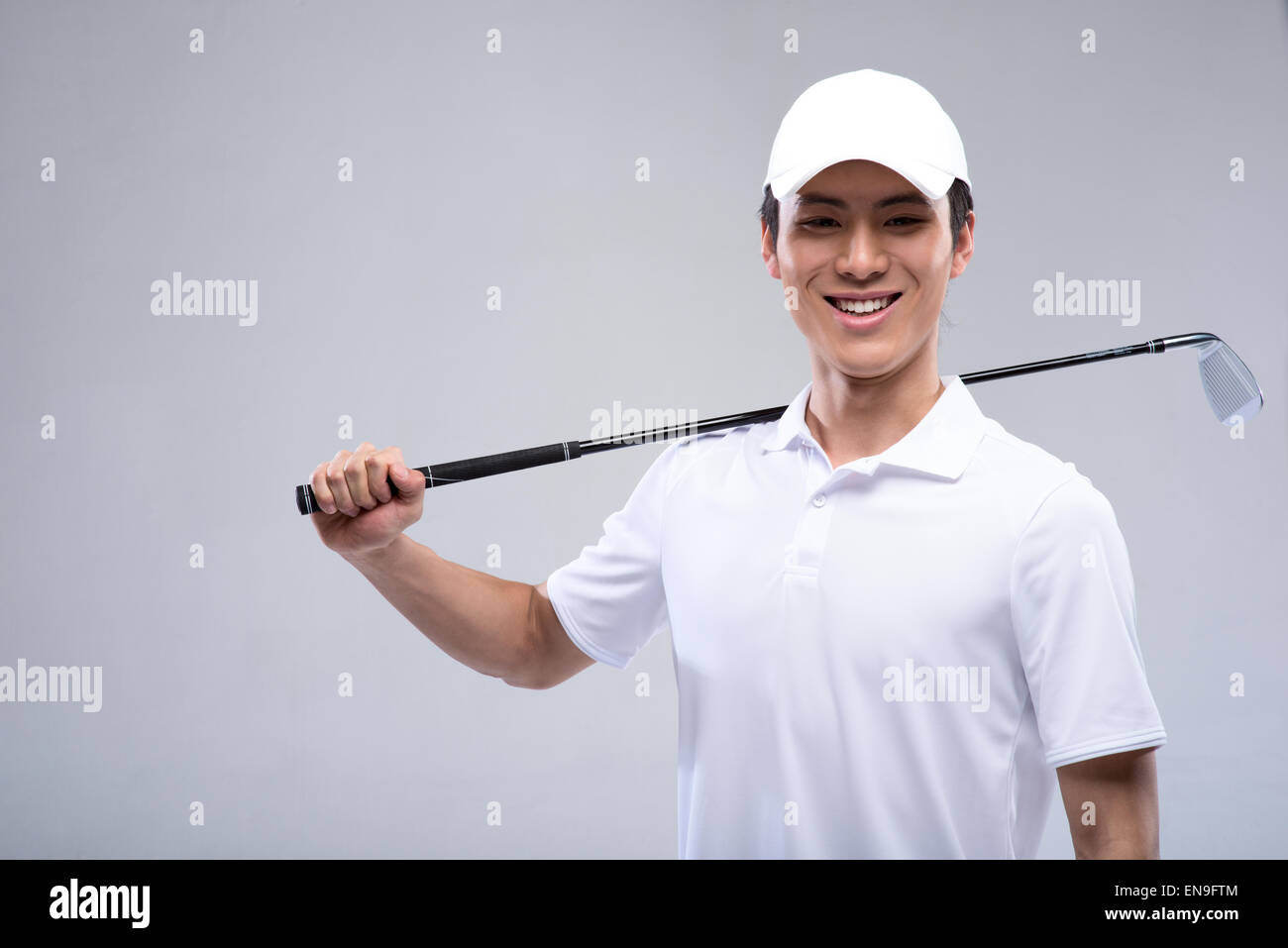 Young man playing golf Stock Photo - Alamy
