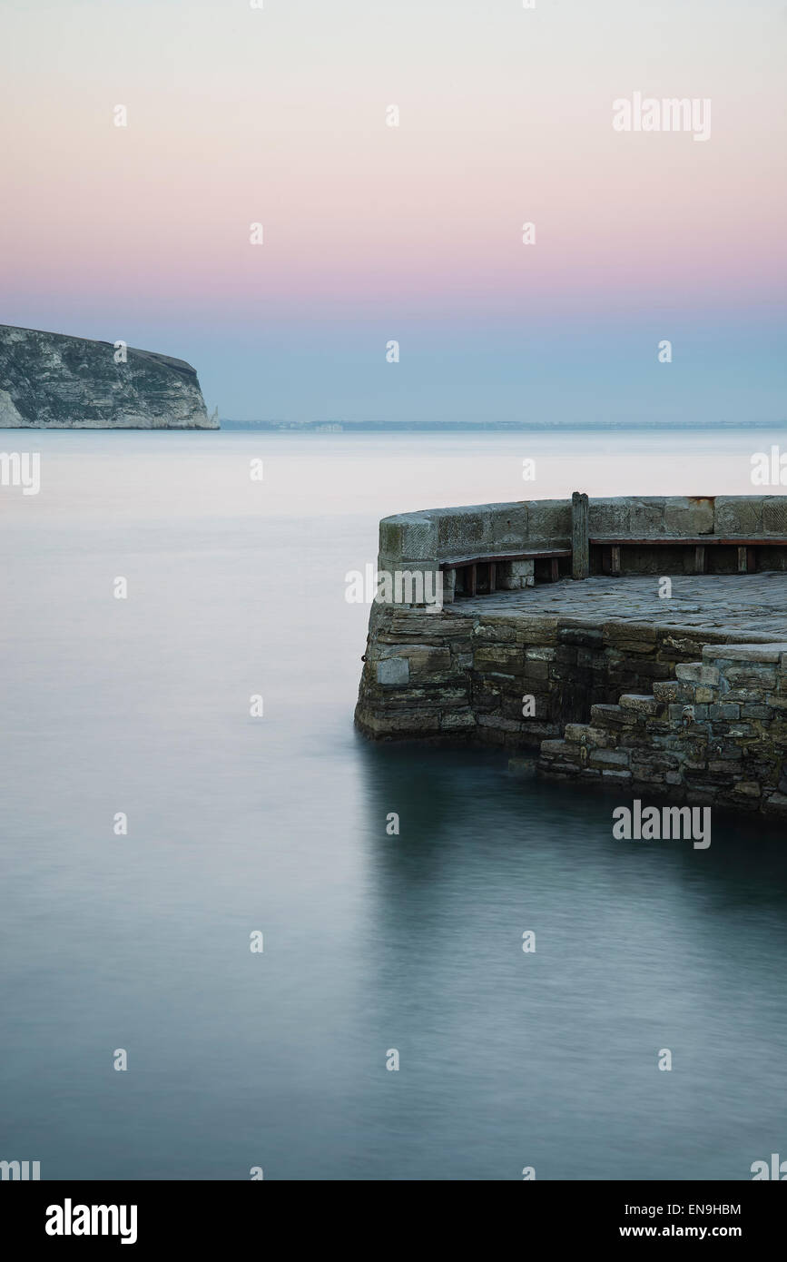 Long exposure landscape of stone jetty in calm seas Stock Photo - Alamy