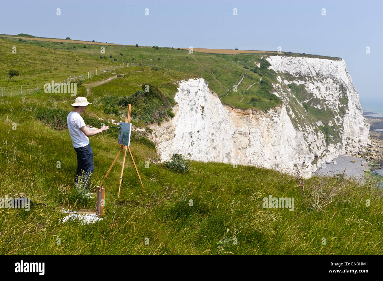 An artist painting the coastline of the Dover Cliffs from the top of ...