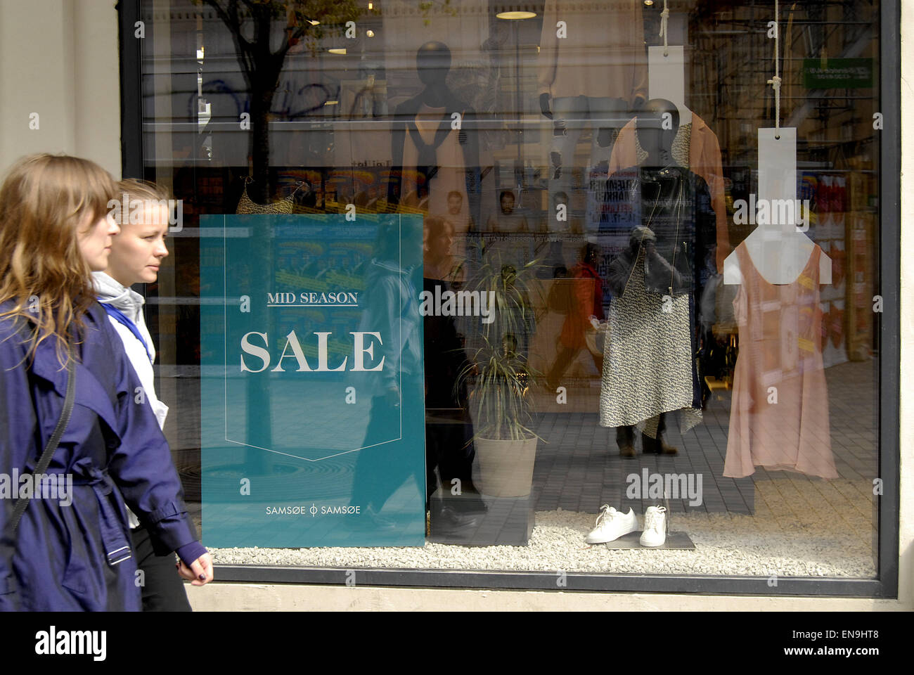 Copenhagen, Denmark. 30th April, 2015. Shoppers walk by store ads with ...