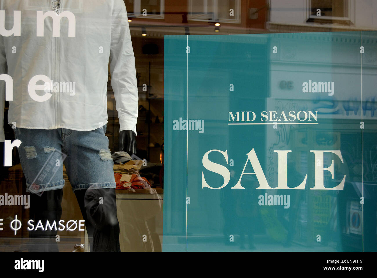 Copenhagen, Denmark. 30th April, 2015. Shoppers walk by store ads with ...