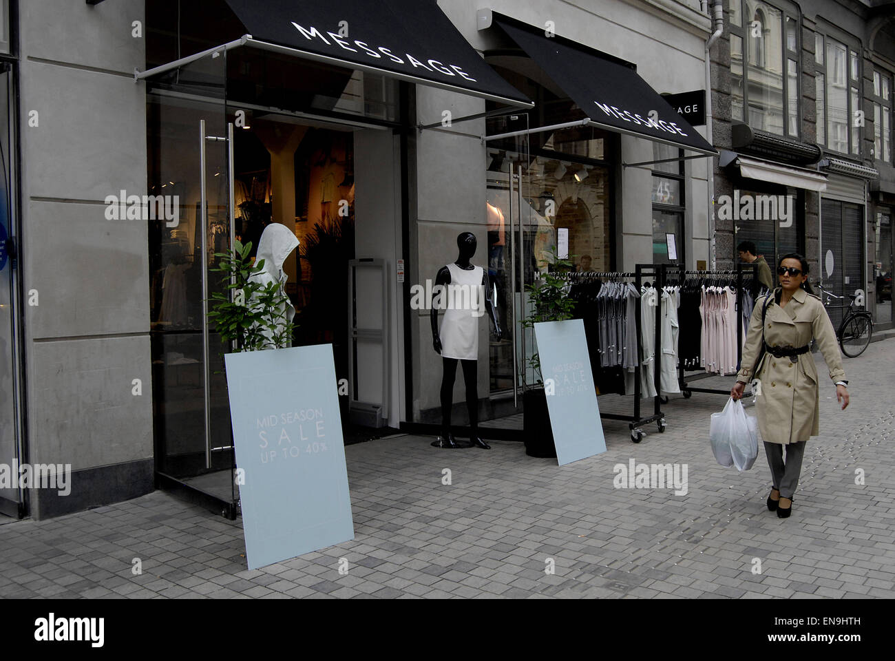 Copenhagen, Denmark. 30th April, 2015. Shoppers walk by store ads with ...