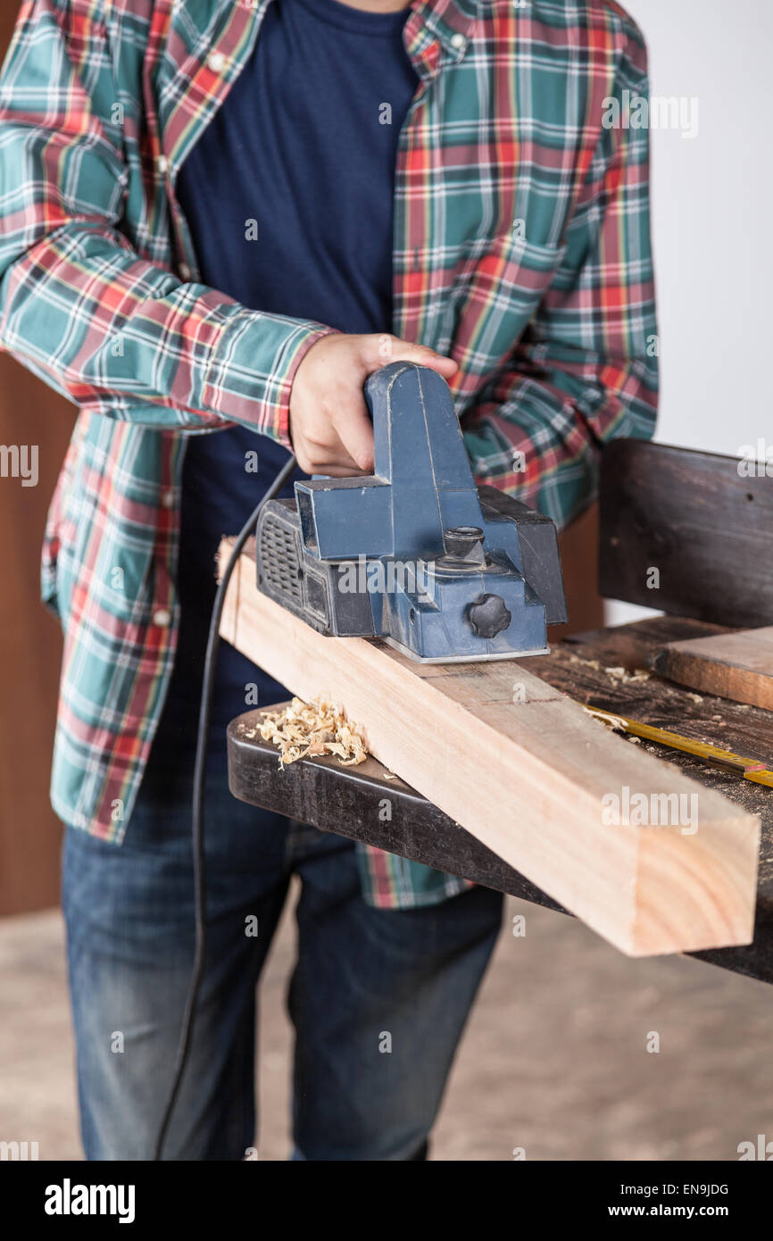 Carpenter cutting wood Stock Photo - Alamy