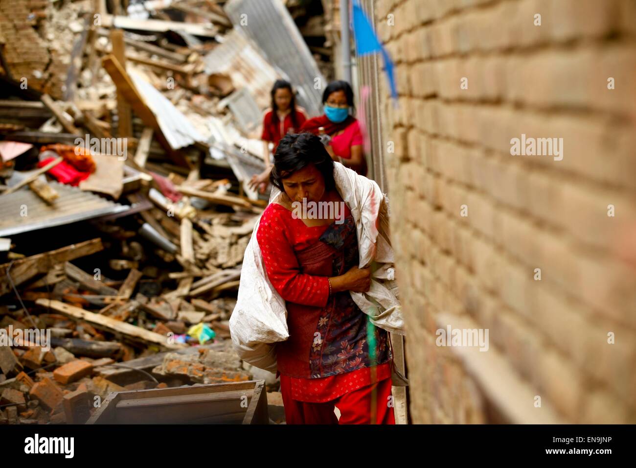 Sankhu, Nepal. 30th Apr, 2015. People walk in debris of destructed ...
