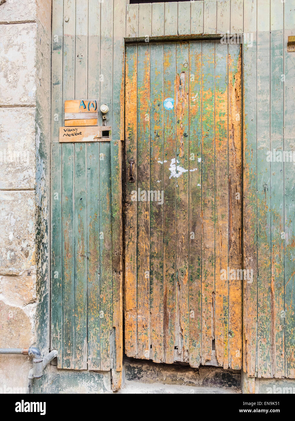 A beat-up wooden front door of a house in Havana Vieja, Cuba Stock ...
