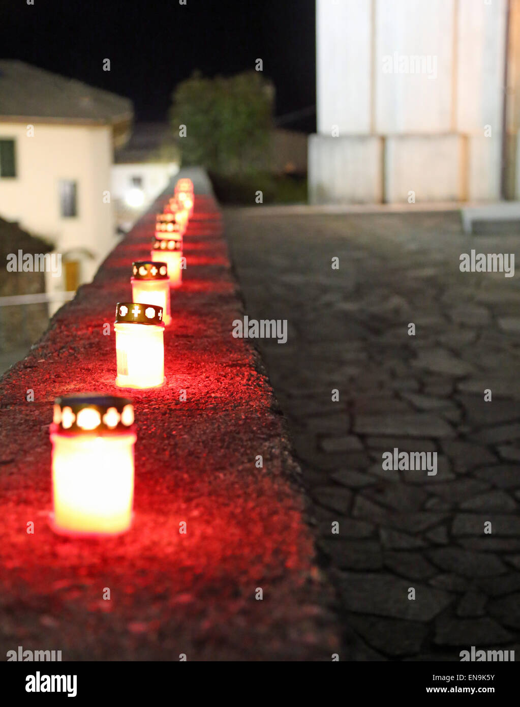 long line of Red candles in the churchyard during mass outdoors at ...
