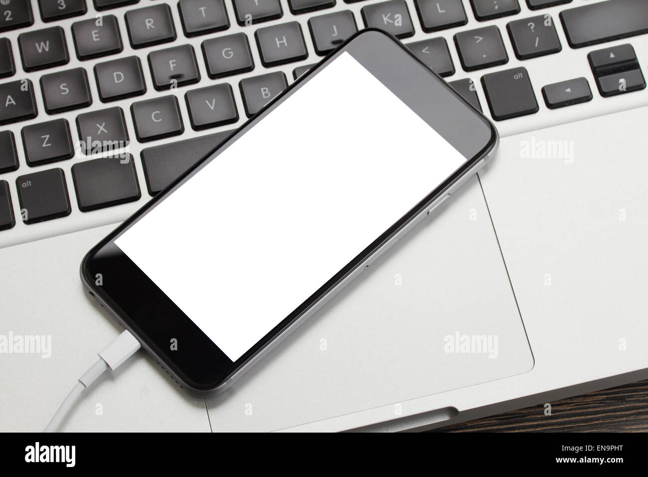 modern phone laying on laptop keyboard Stock Photo - Alamy