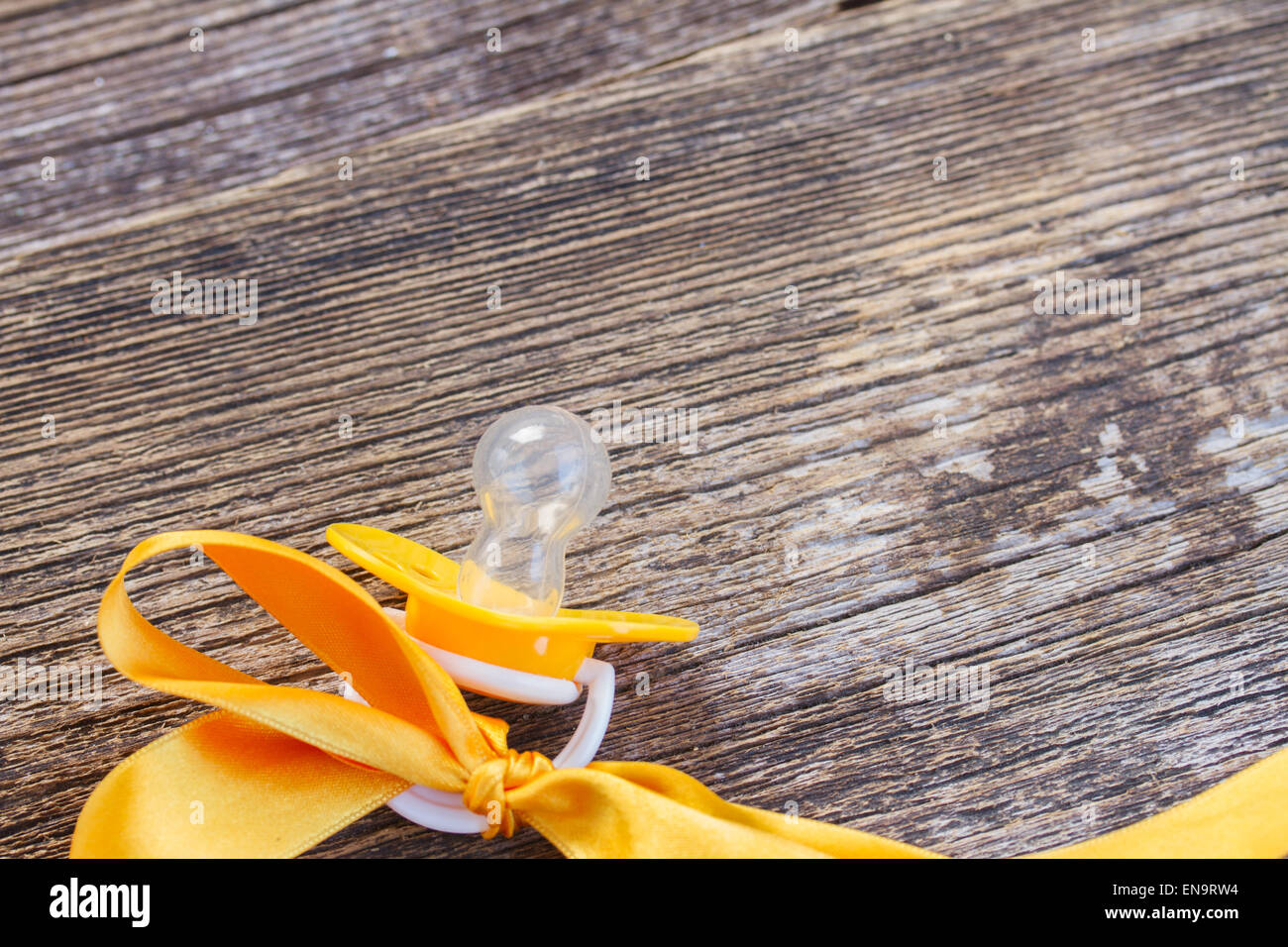 baby pacifier on wooden table Stock Photo - Alamy