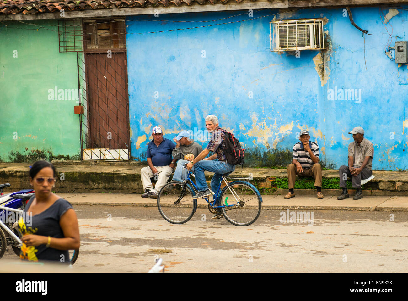 Cuba Vinales typical road street scene old men chat pavement cyclist ...