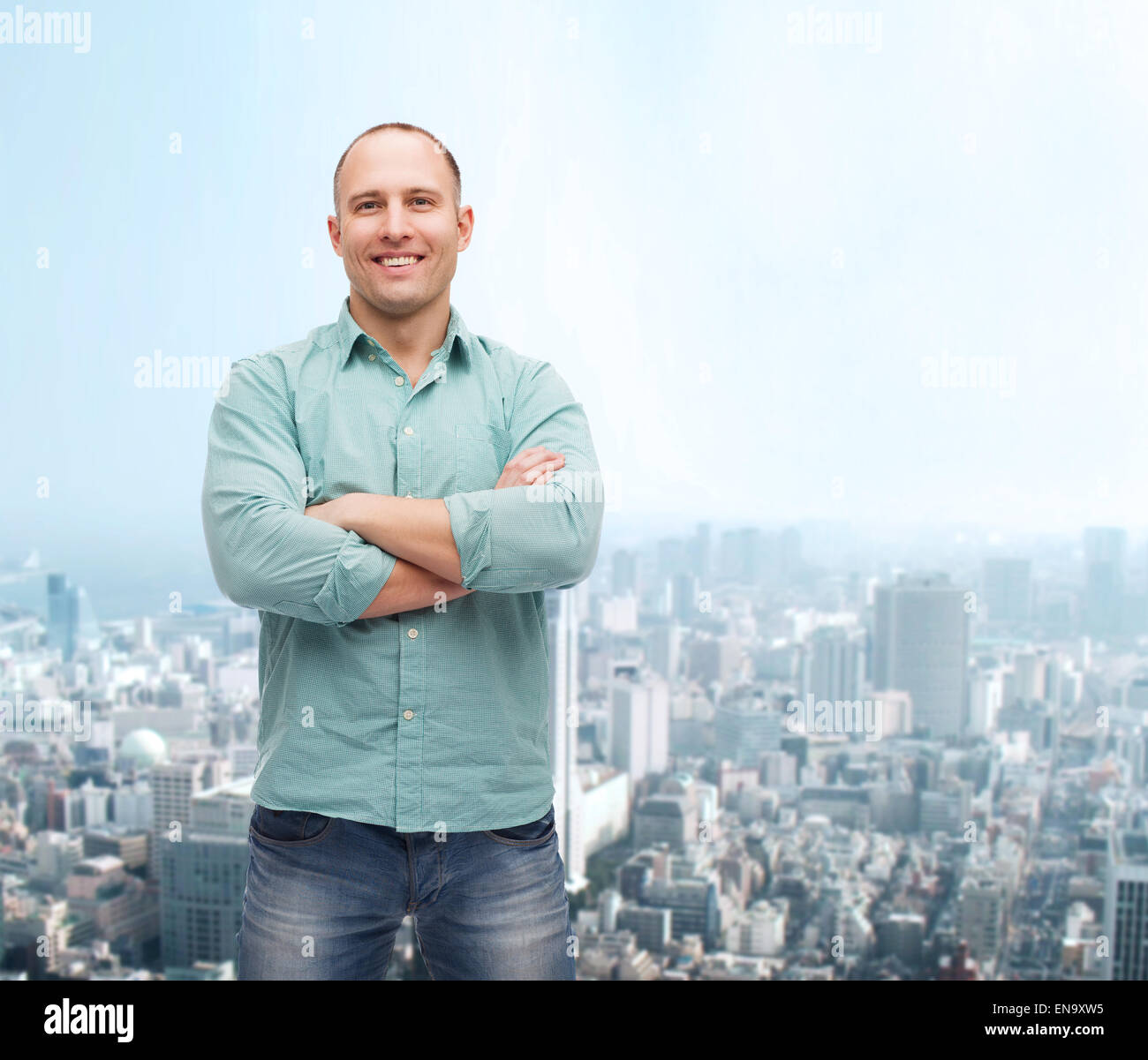 smiling man with crossed arms Stock Photo - Alamy