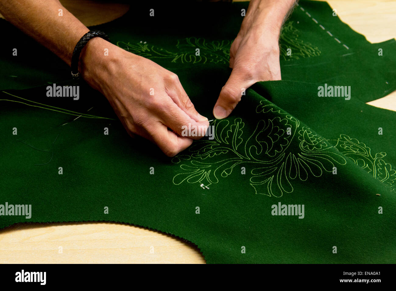 embroidering the green Loden vest of a traditional costume in ...