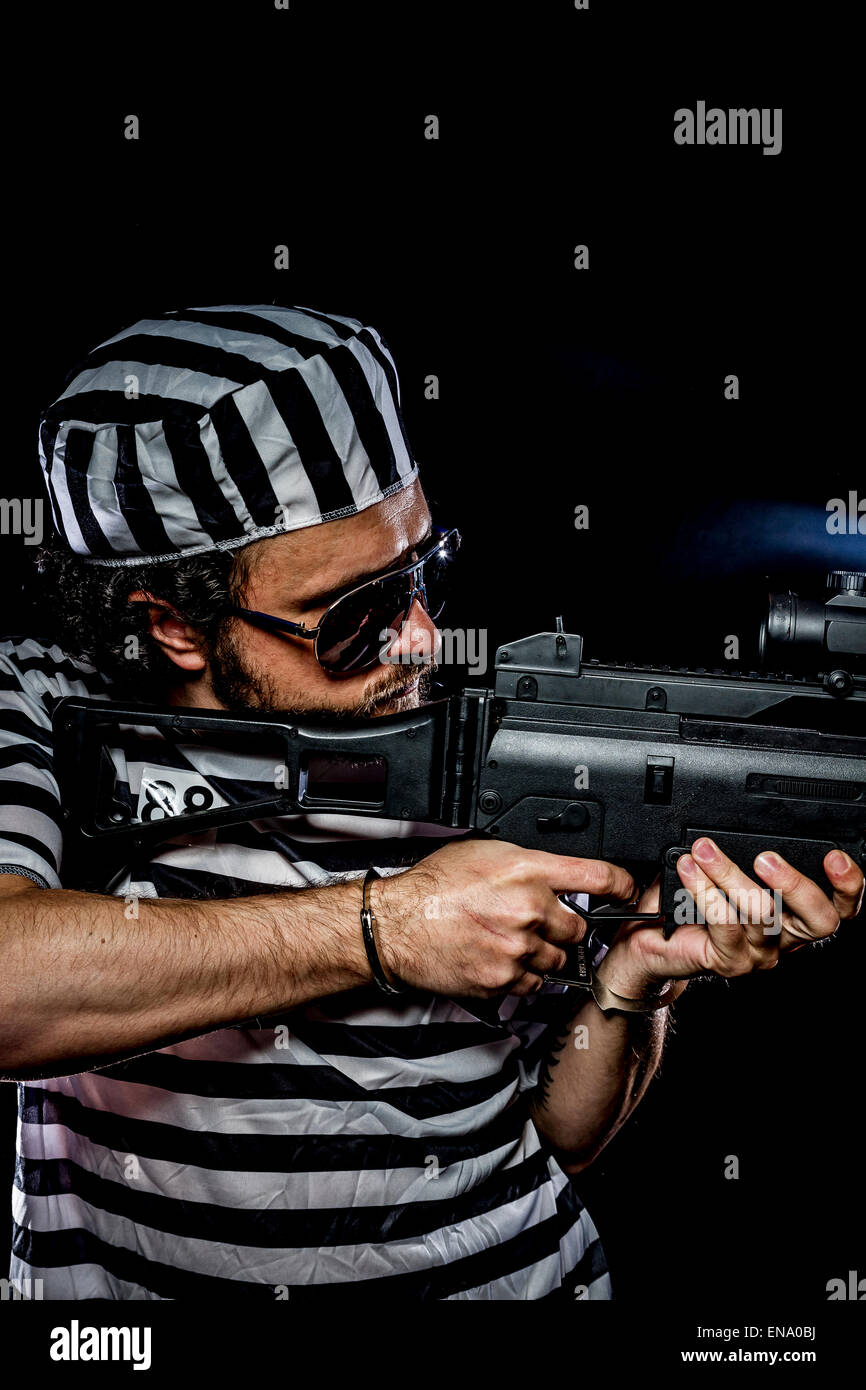 disorders .Prison riot concept. Man holding a machine gun, prisoner ...