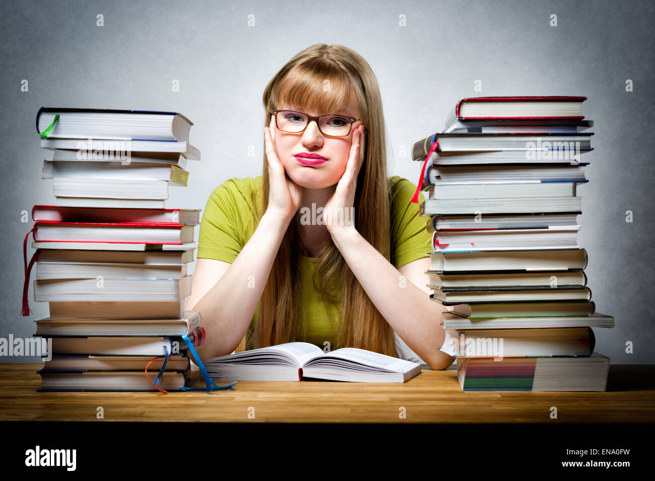 Teen girl student bored table reading hi-res stock photography and ...