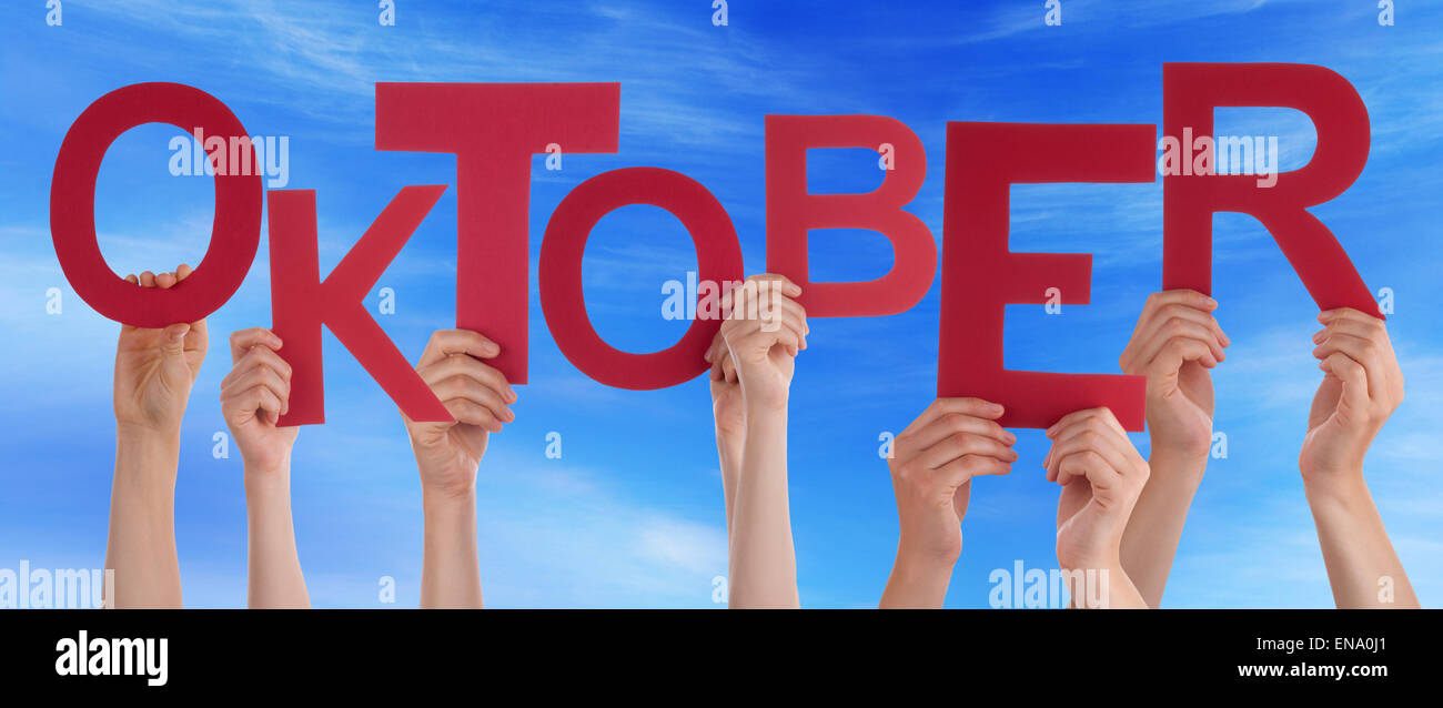 People Holding Word Oktober Means October Blue Sky Stock Photo - Alamy