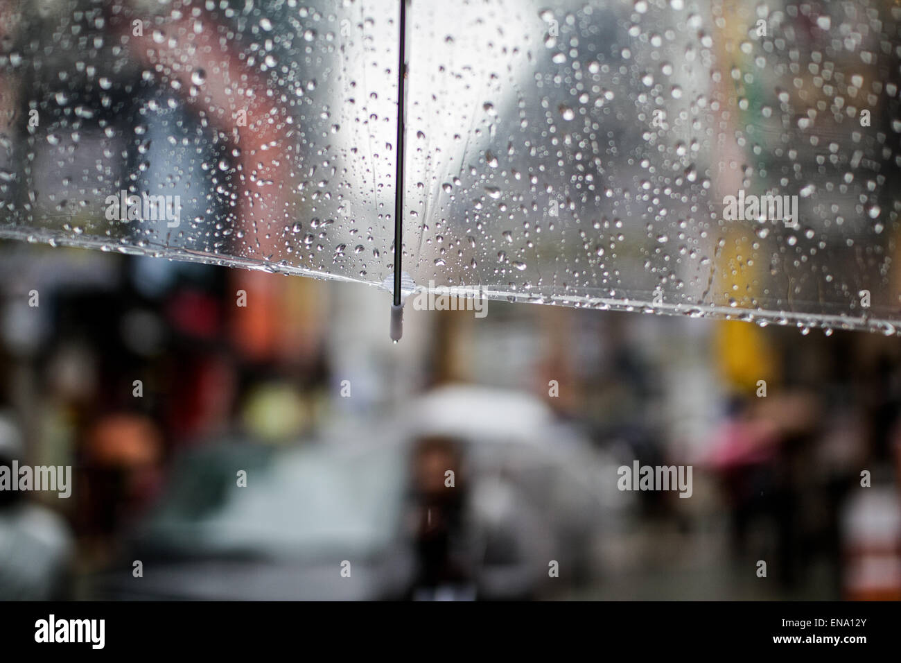 Point of view inside a transparent umbrella with rain drops with a ...