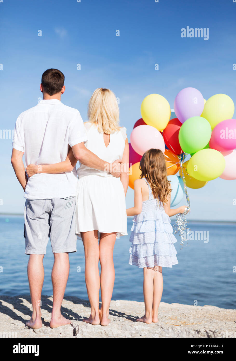 happy family at the seaside with bunch of balloons Stock Photo - Alamy