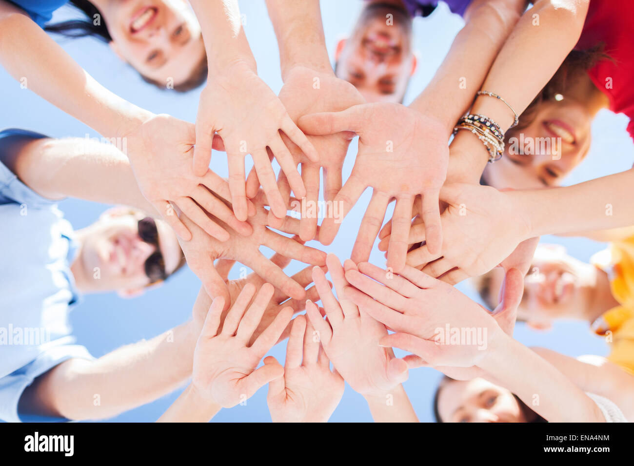teenagers hands on top of each other outdoors Stock Photo - Alamy