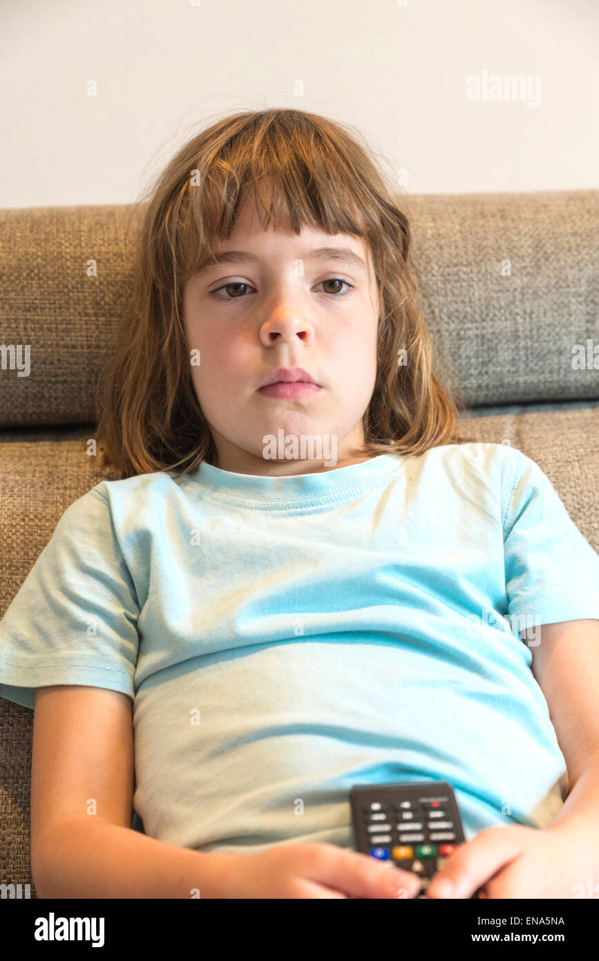 Child watching television remote hi-res stock photography and images ...