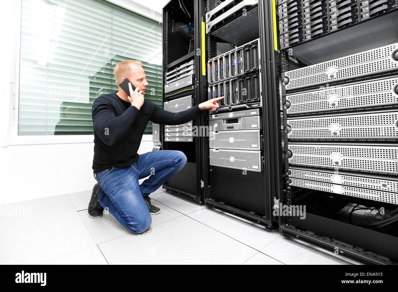 IT consultant calling support in datacenter Stock Photo - Alamy