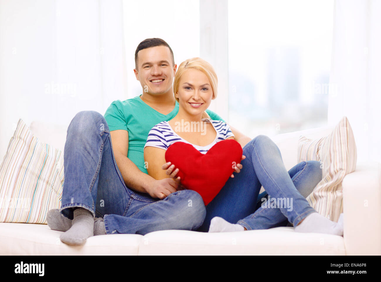 smiling happy couple with red heart at home Stock Photo - Alamy