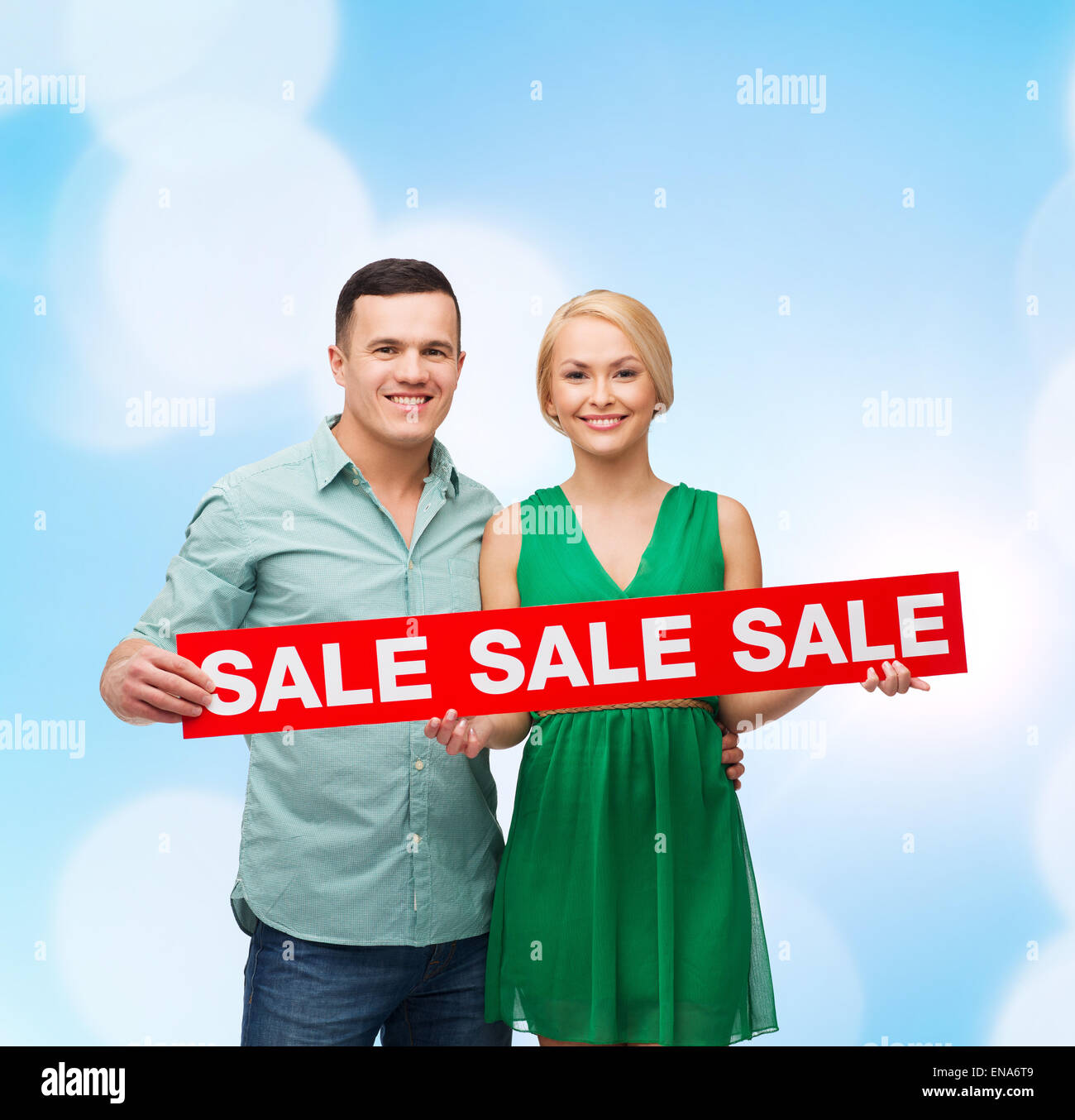 smiling couple with sale sign Stock Photo - Alamy