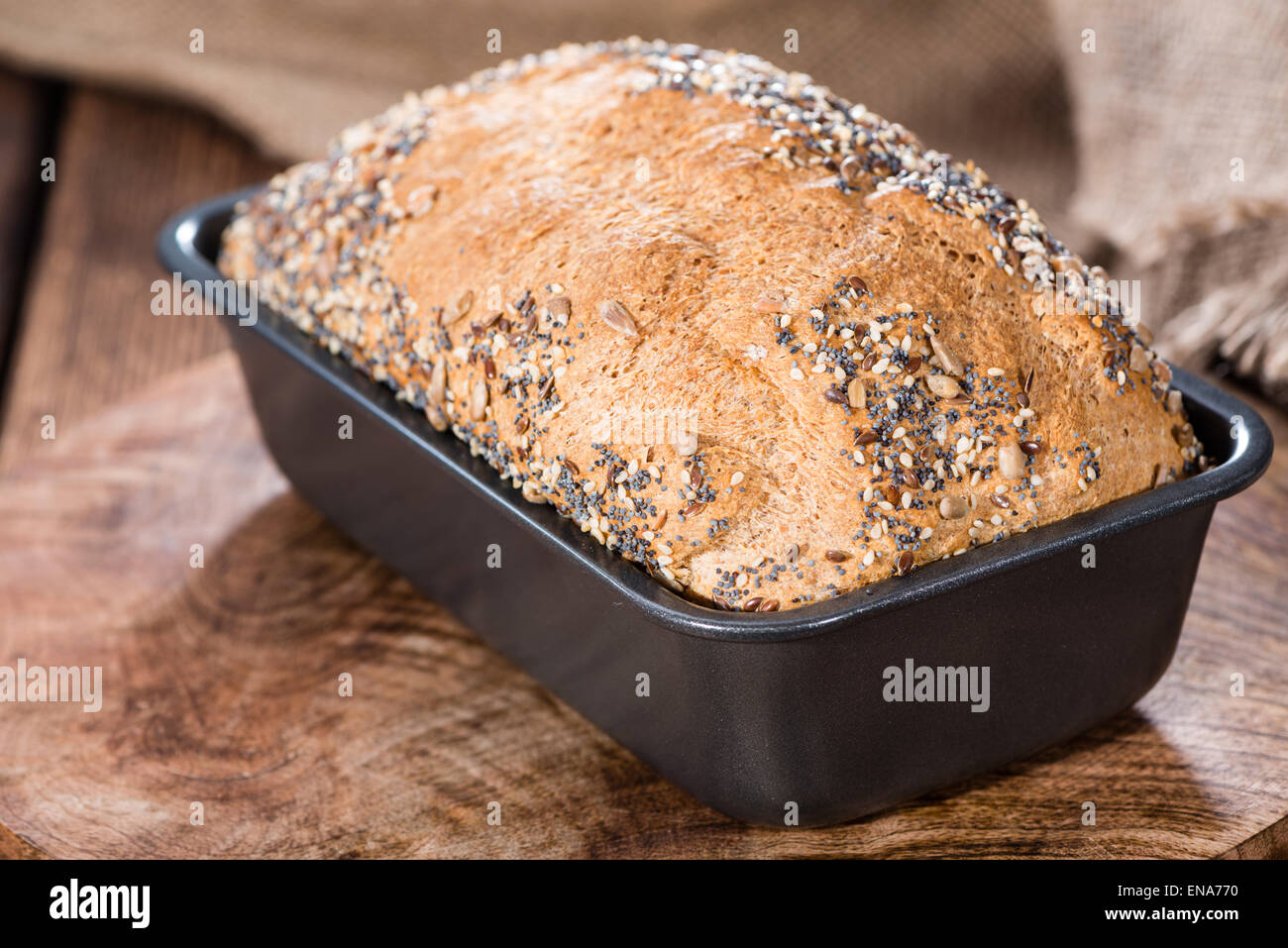 Loaf of bread (fresh baked) on rustic wooden background Stock Photo - Alamy