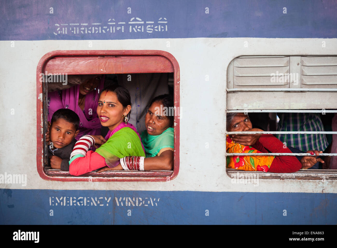 Passengers at the window of a second class train carriage at the ...