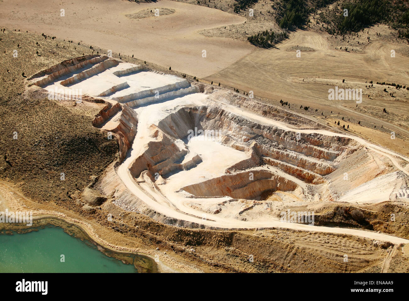 An aerial view of the tiers and levels of excavation in an open pit ...