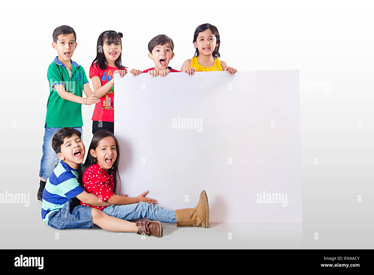 indian Kids groups Friends Showing Message Board Stock Photo - Alamy