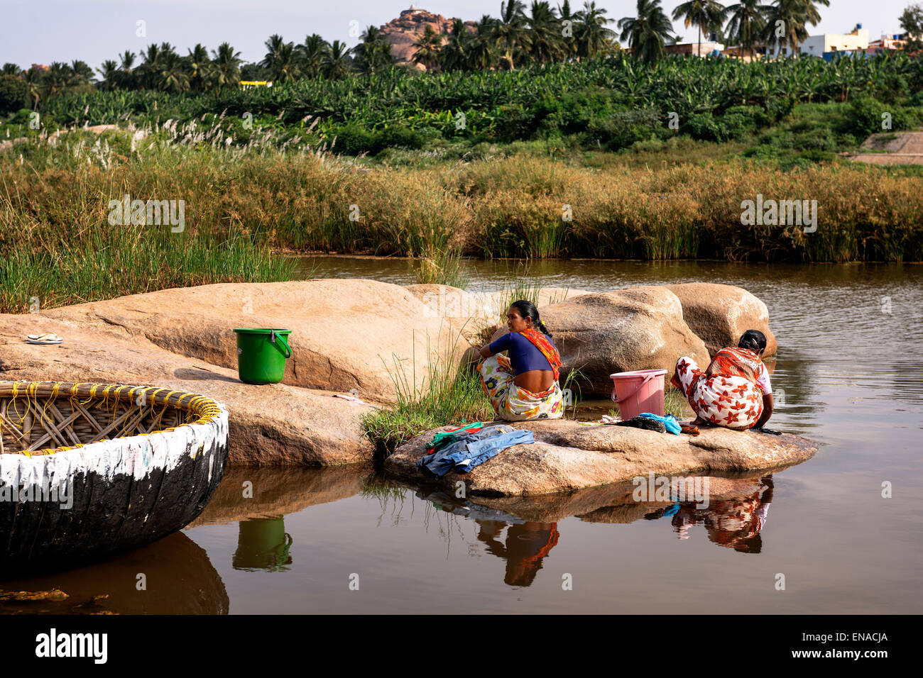 Women washing clothes in the river, Hampi Stock Photo - Alamy