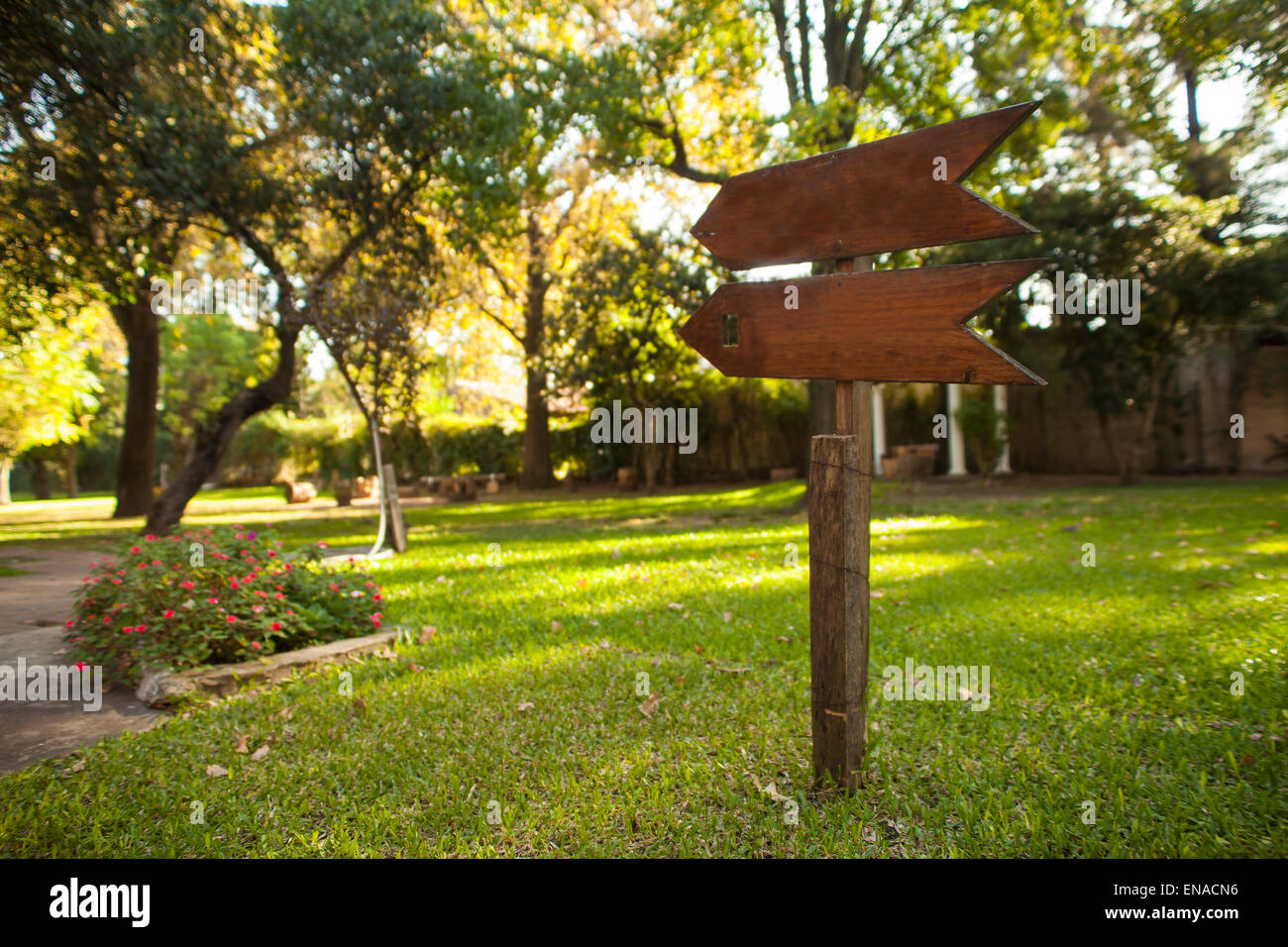 wooden garden sign pointing down the path Stock Photo - Alamy