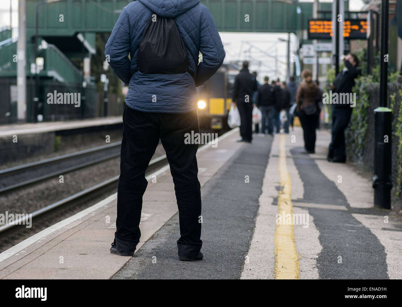 Young man traveling on train - train pulling into station Stock Photo ...