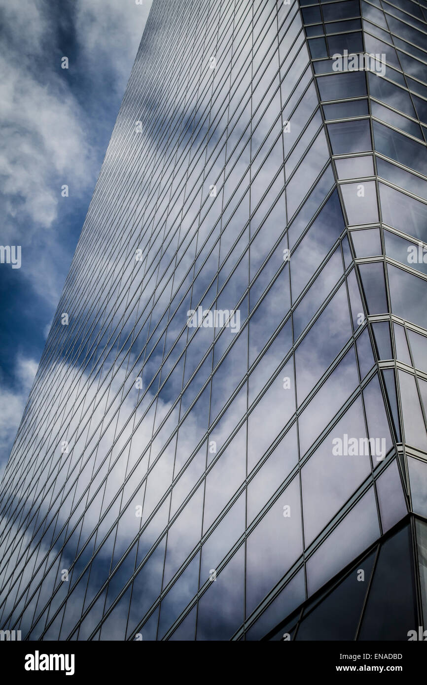 center, skyscraper with glass facade and clouds reflected in windows ...