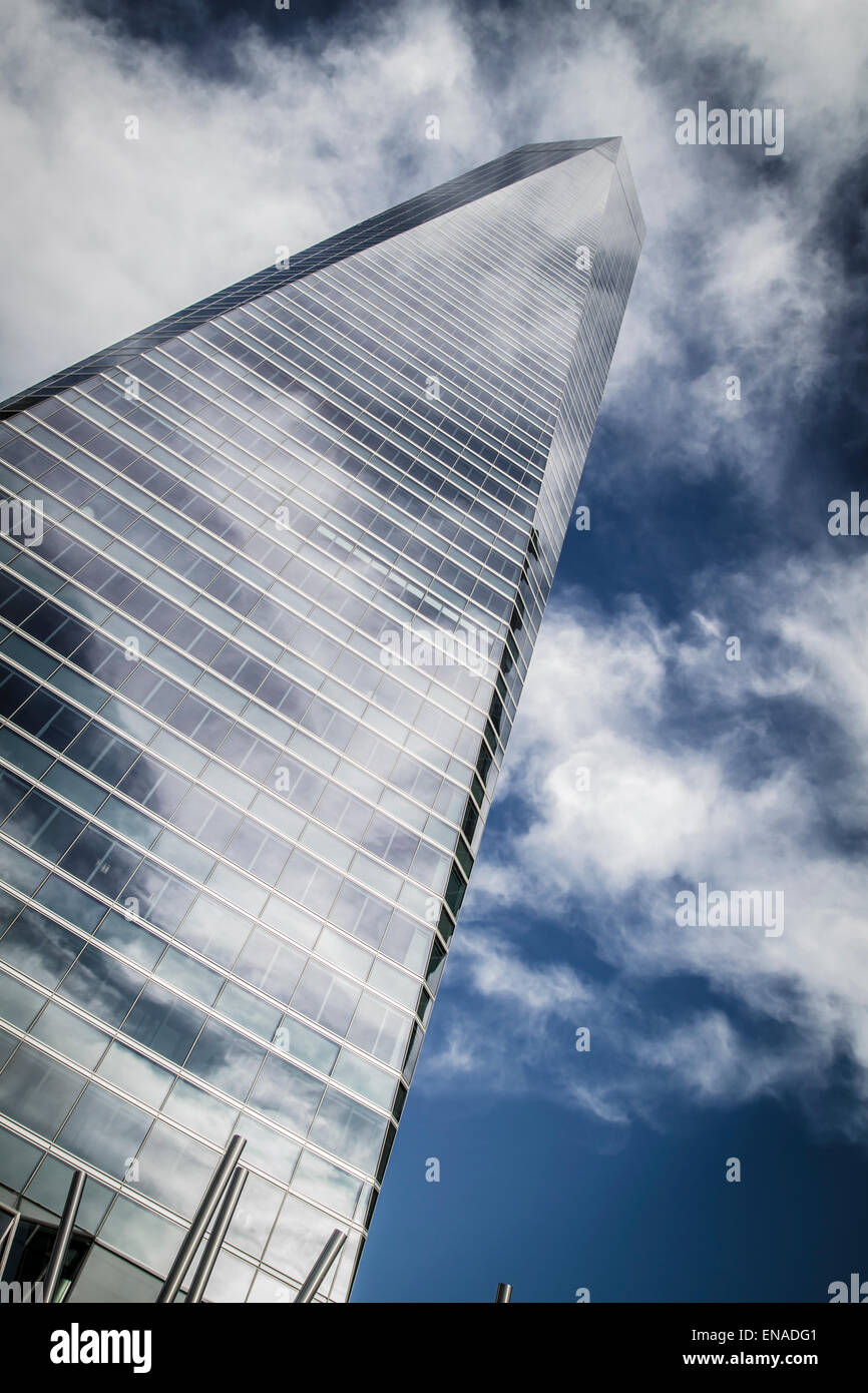 finance, skyscraper with glass facade and clouds reflected in windows ...