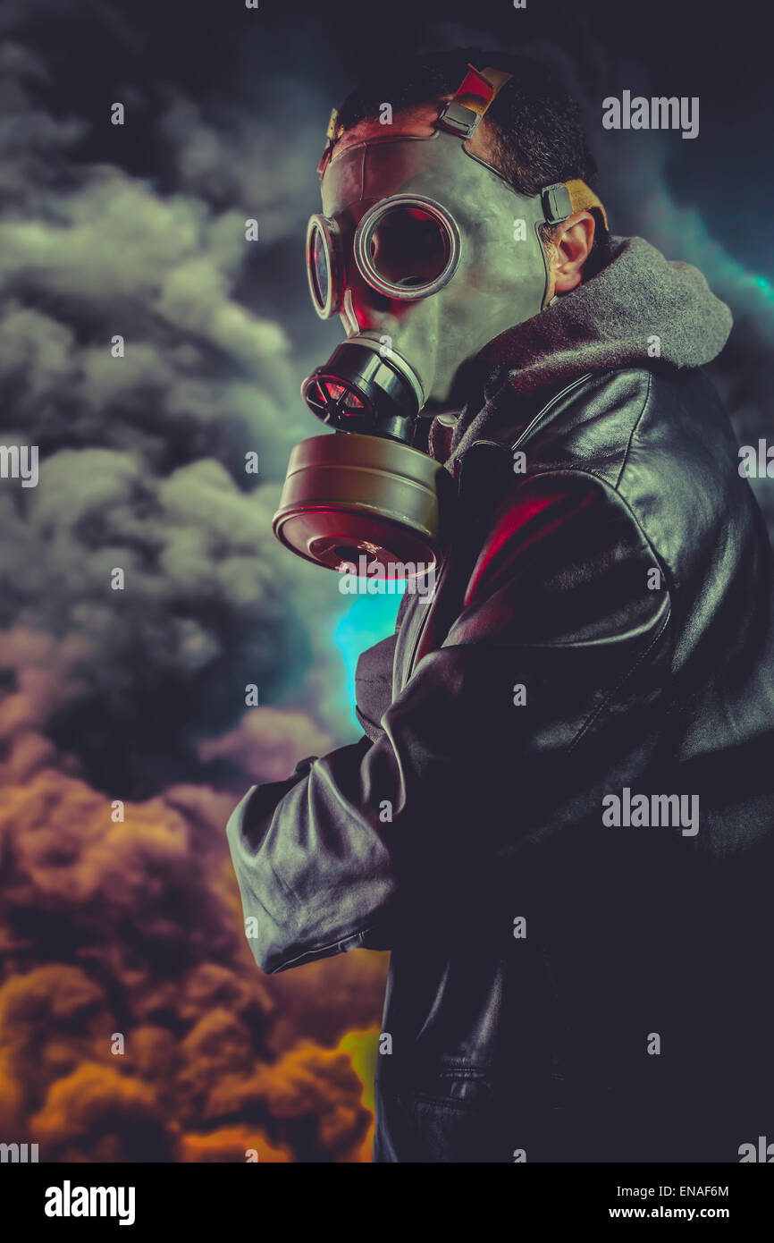 Armed man with gas mask over explosion background Stock Photo - Alamy