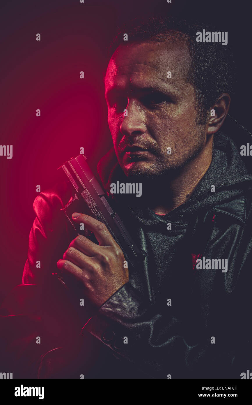 Robber with gun over red background Stock Photo - Alamy