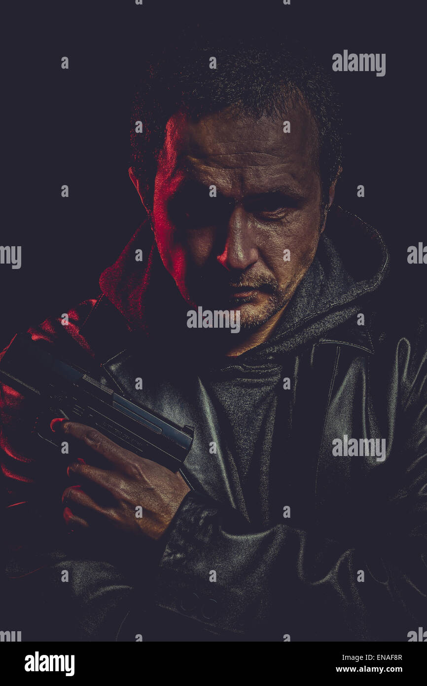 Gangster, man with a gun ready to shoot Stock Photo - Alamy