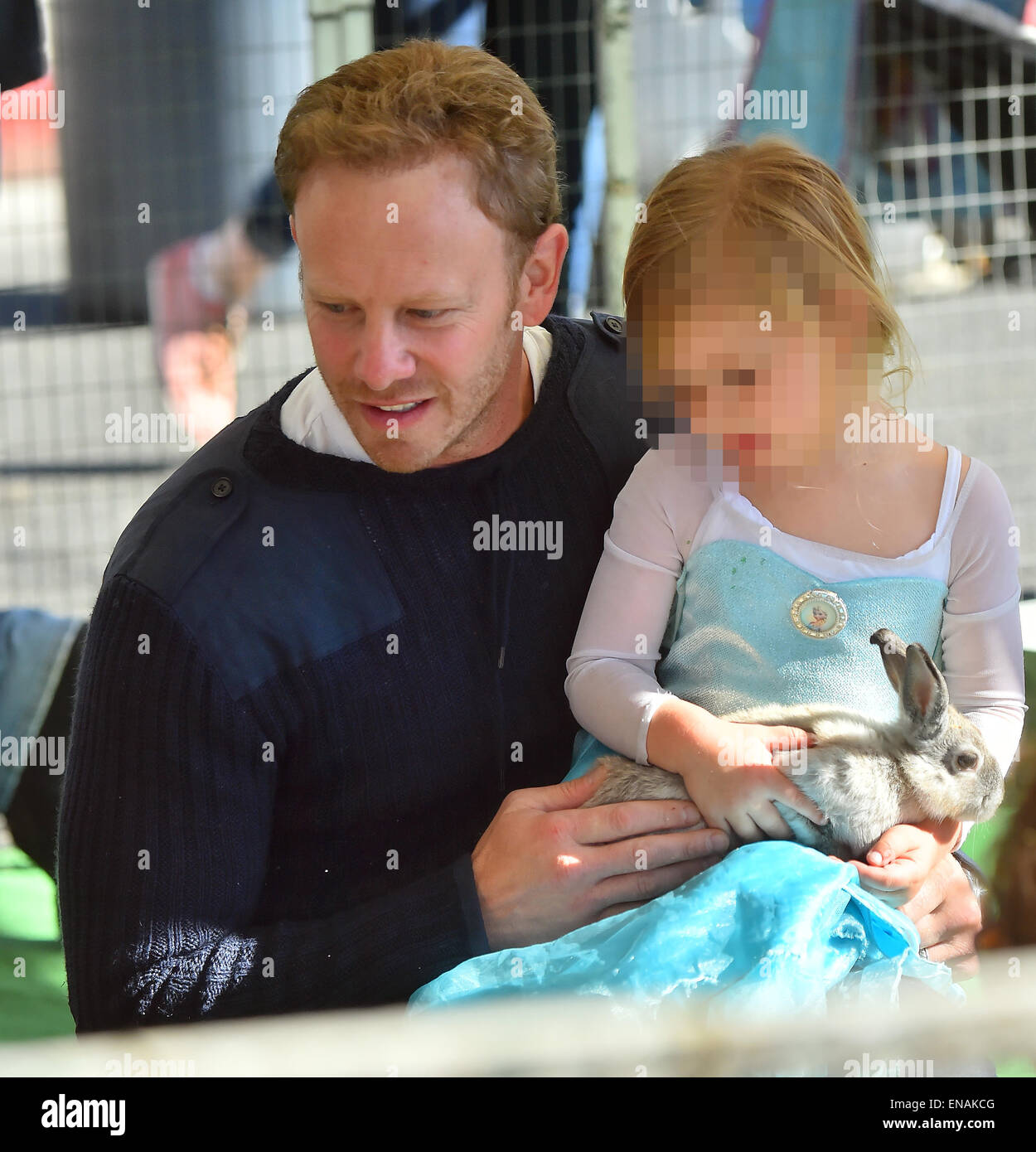 Ian Ziering and his two daughters play with the rabbits at the Farmer's ...