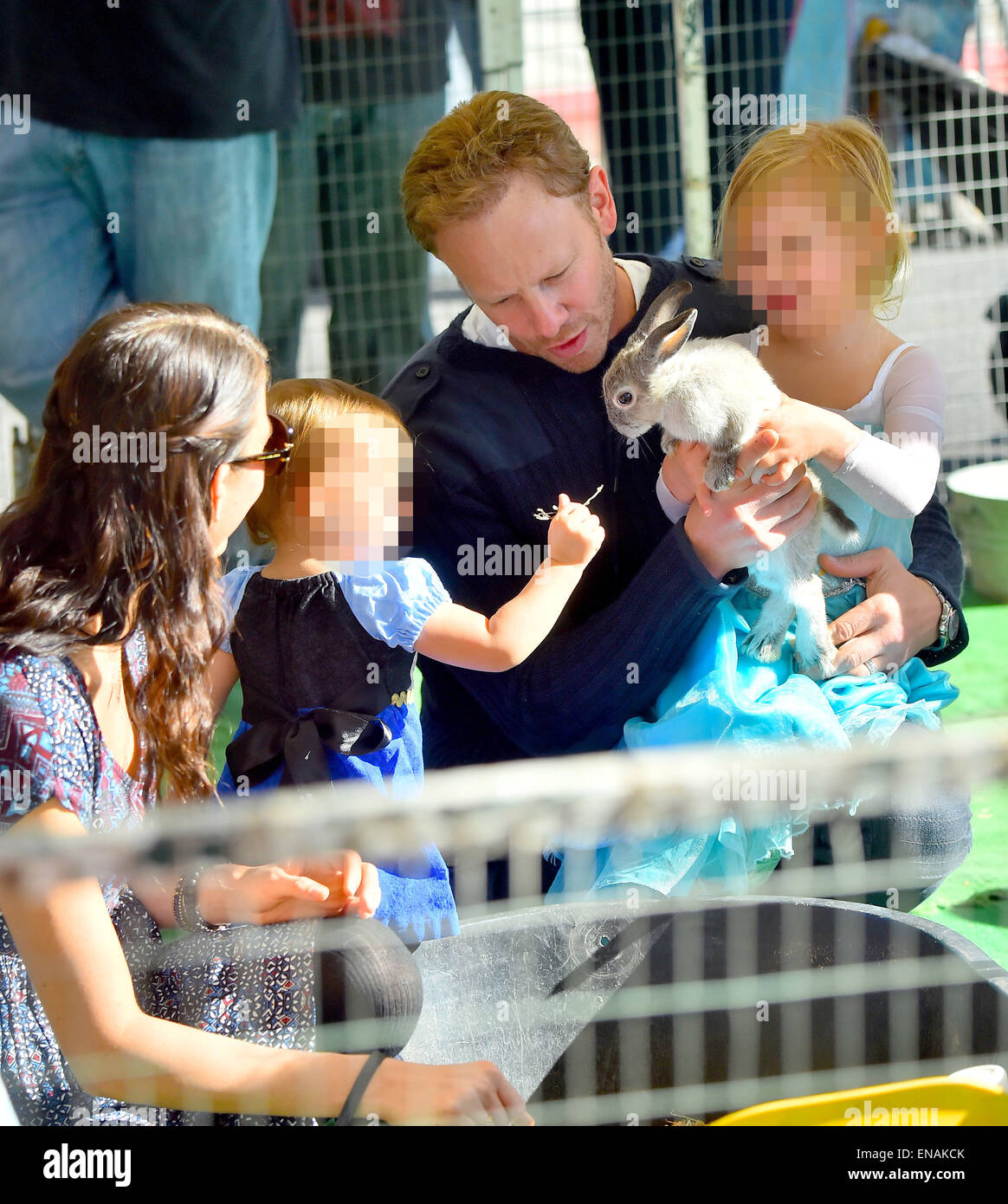 Ian Ziering and his two daughters play with the rabbits at the Farmer's ...