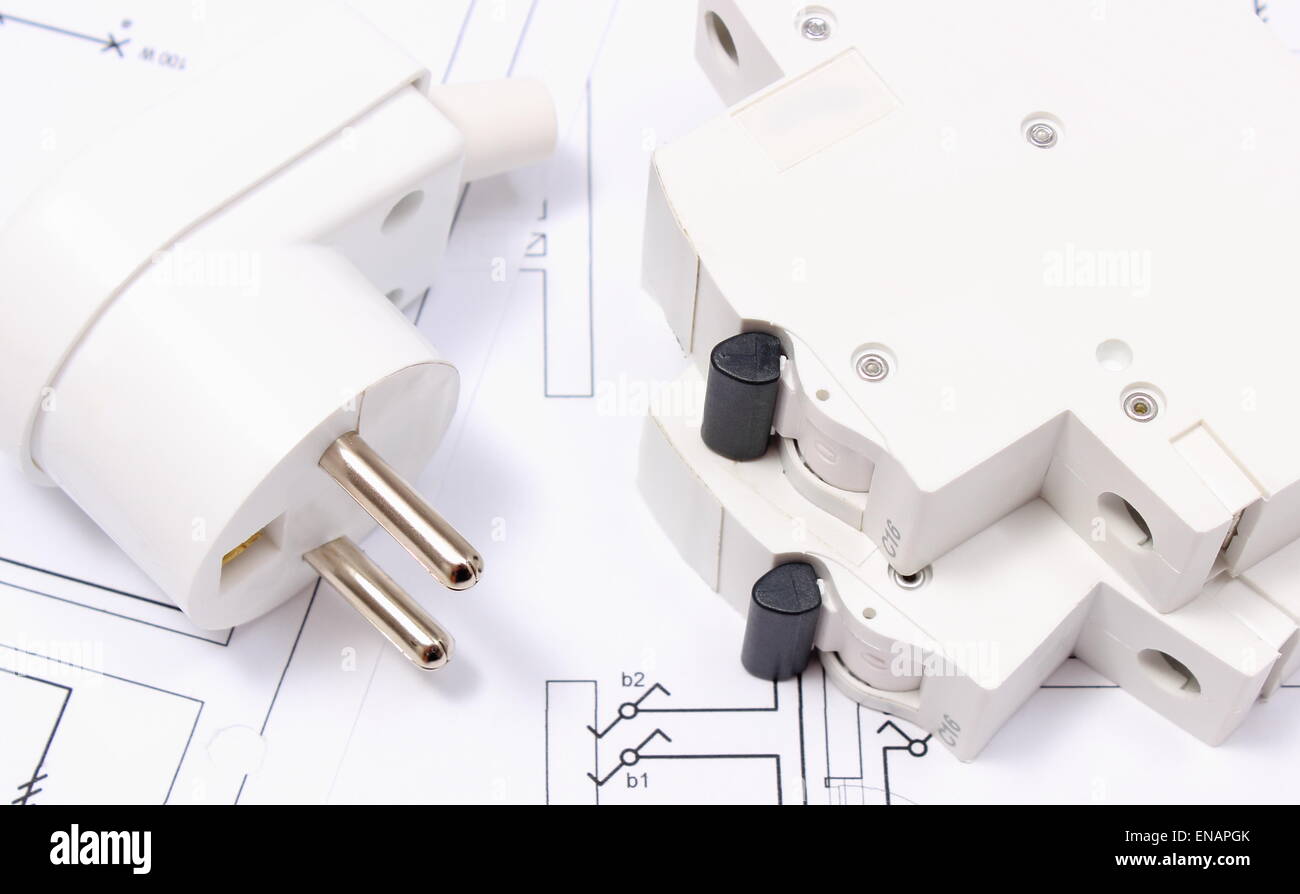 Electric plug and fuse lying on construction drawing of house ...