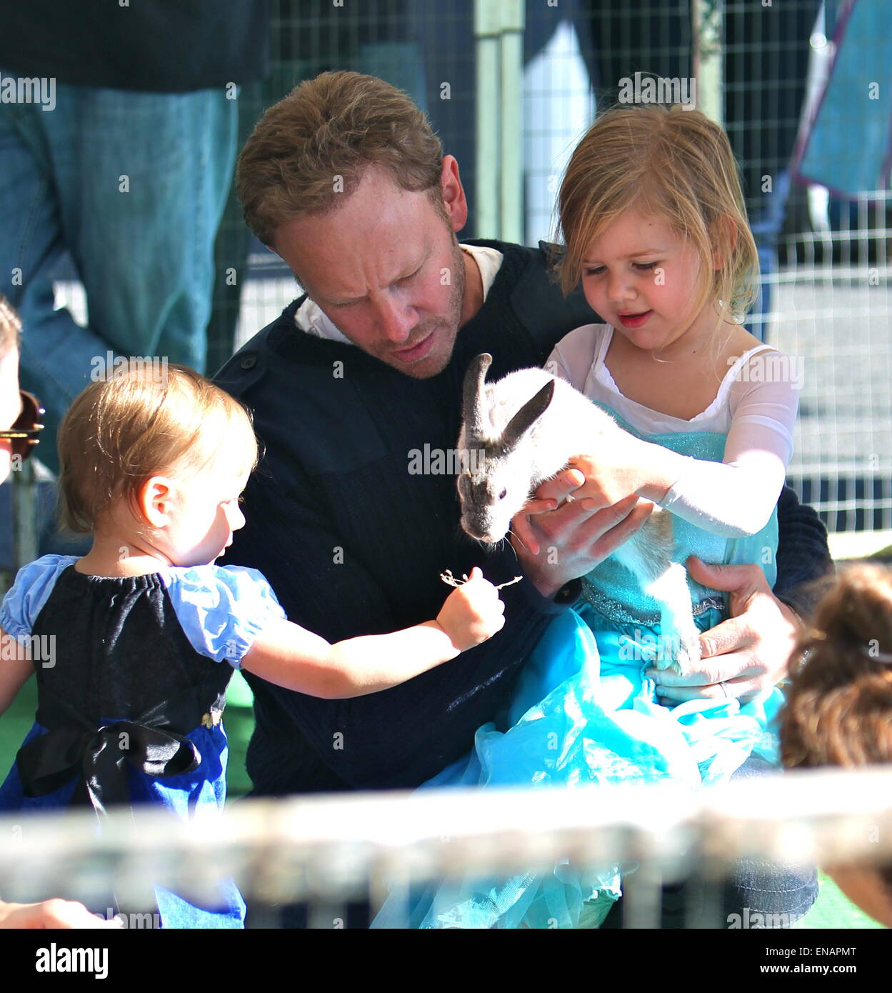 Ian Ziering and his daughters, Penna and Mia, play with a rabbit at the ...
