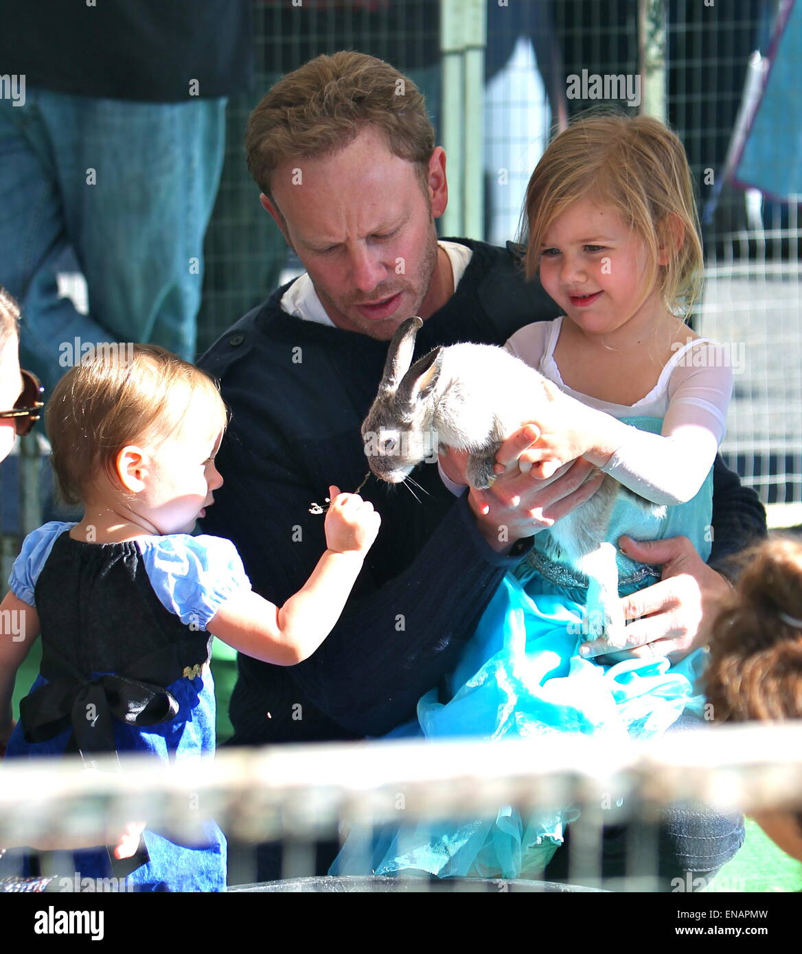 Ian Ziering and his daughters, Penna and Mia, play with a rabbit at the ...