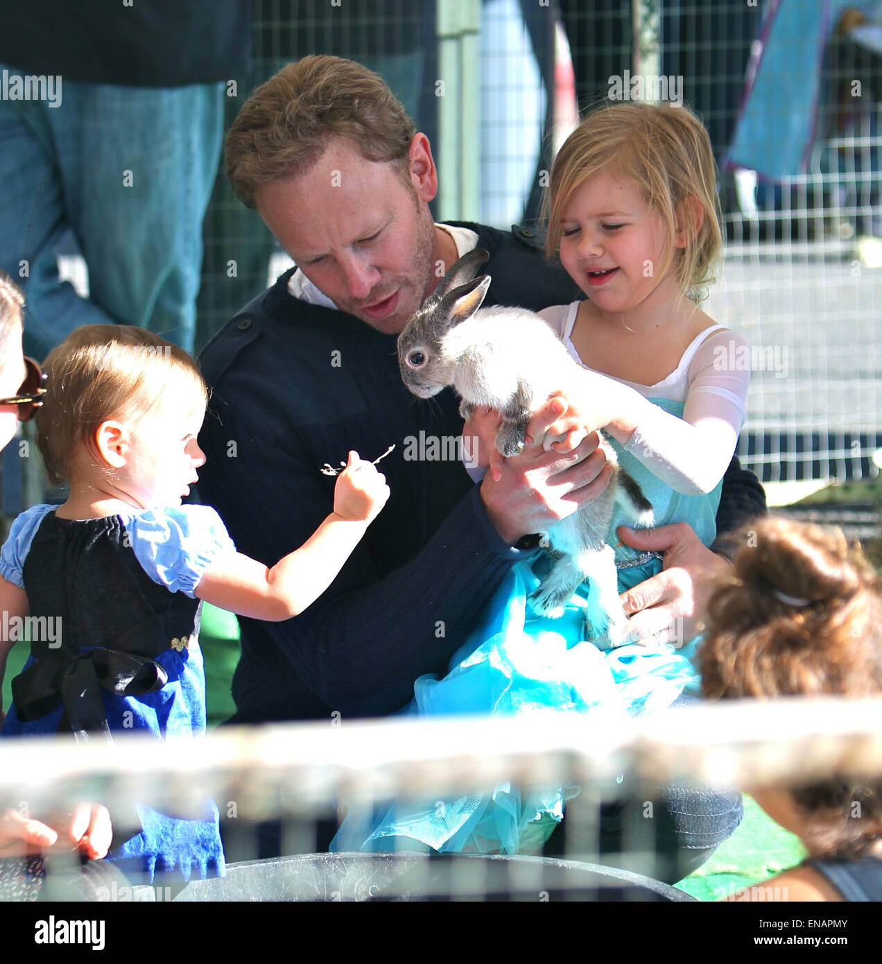 Ian Ziering and his daughters, Penna and Mia, play with a rabbit at the ...