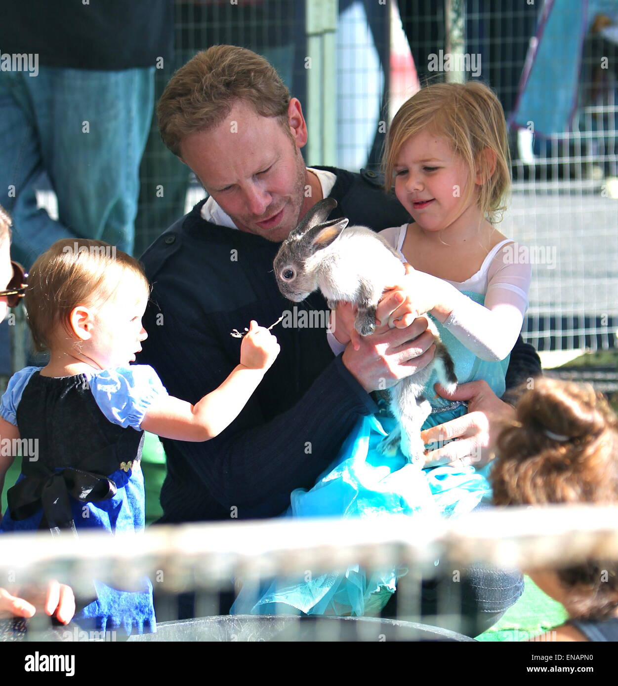 Ian Ziering and his daughters, Penna and Mia, play with a rabbit at the ...
