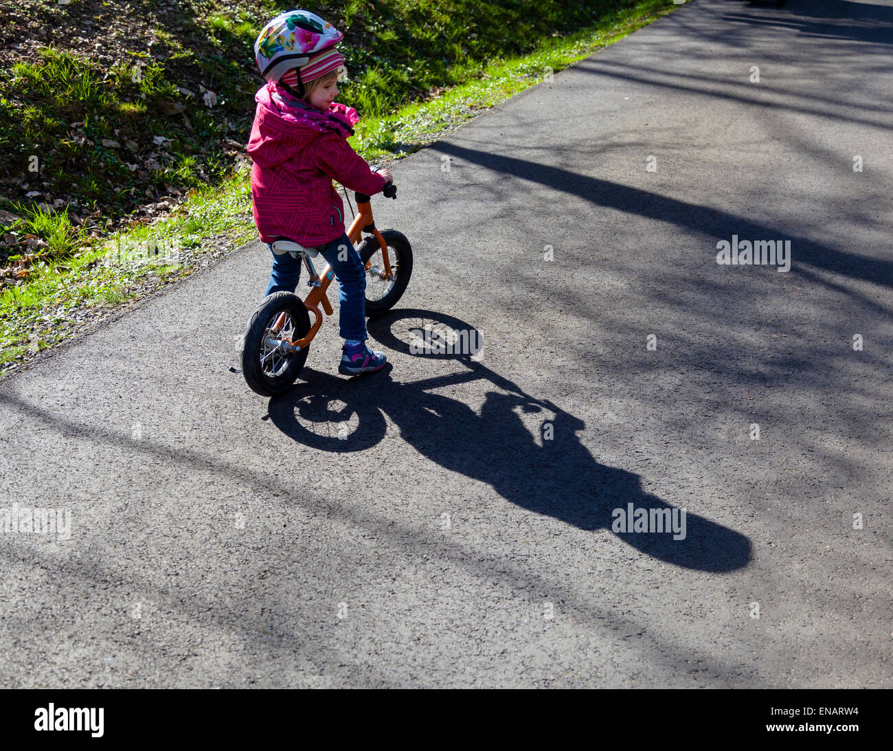 Shadow girl riding bike hi-res stock photography and images - Alamy