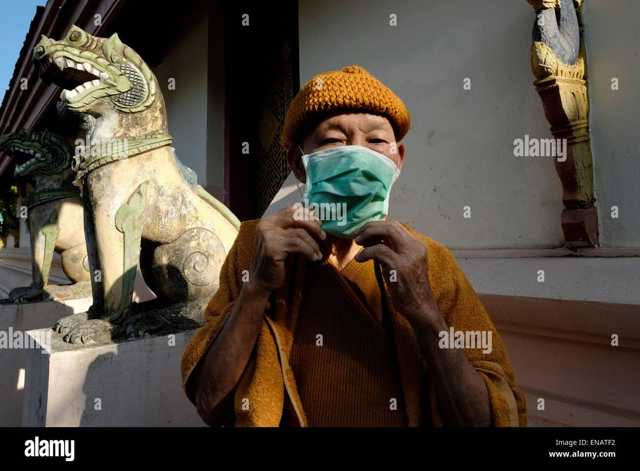 A Buddhist monk wearing a surgical mask at Sri Khun Muane temple in the ...