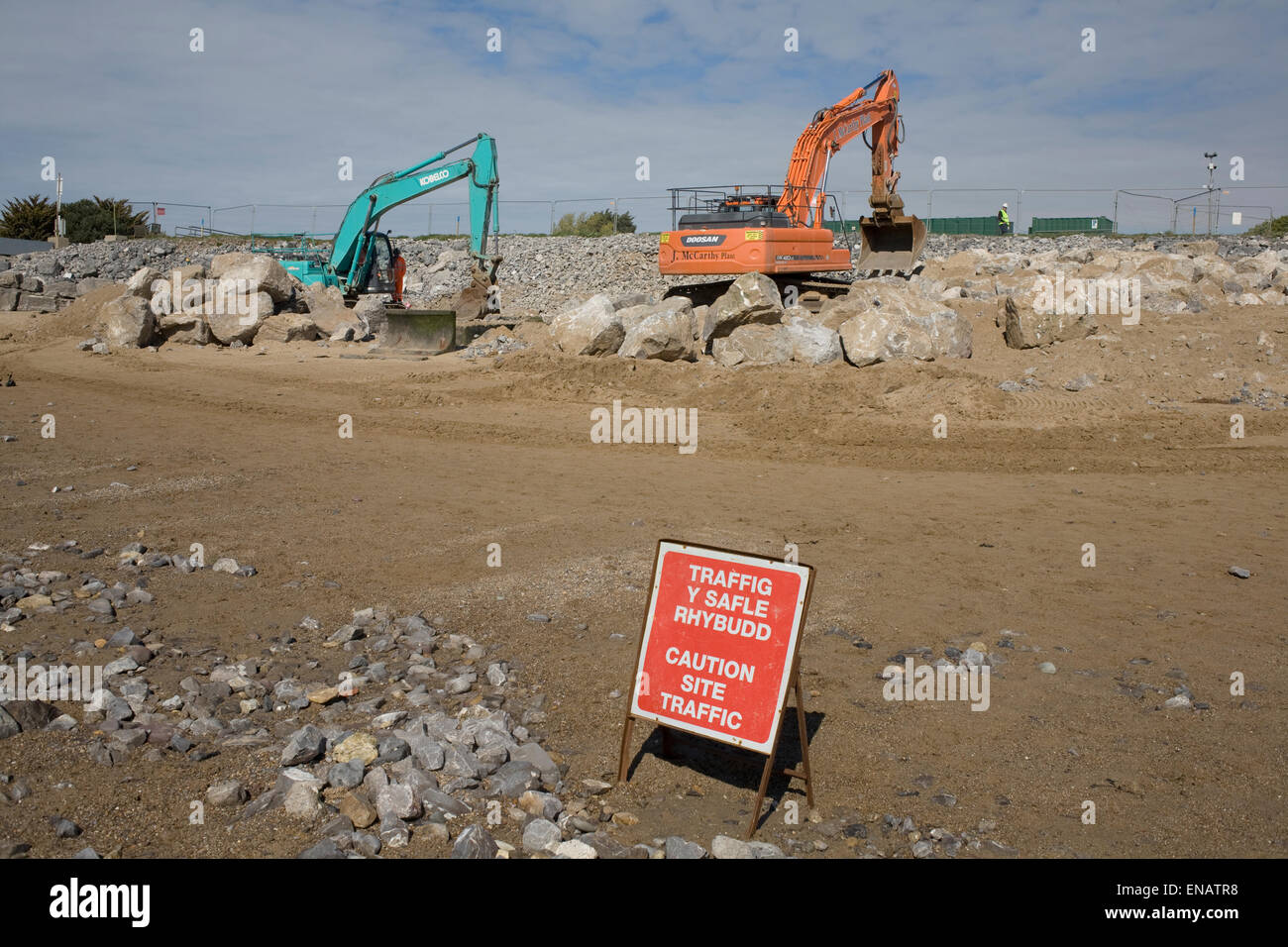 turquoise and orange diggers made by doosa,kobelco working on site in ...