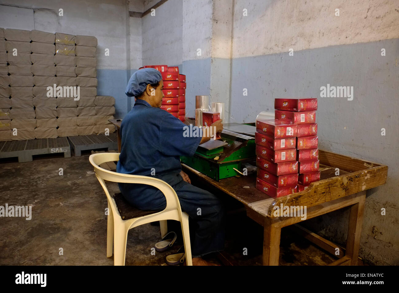 Woman working at the assembly line of SeyTe tea factory in Mahe Island ...